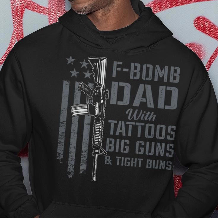 F Bomb Dad Tattoos Big Guns Tight Buns Gun On Back Hoodie - Monsterry